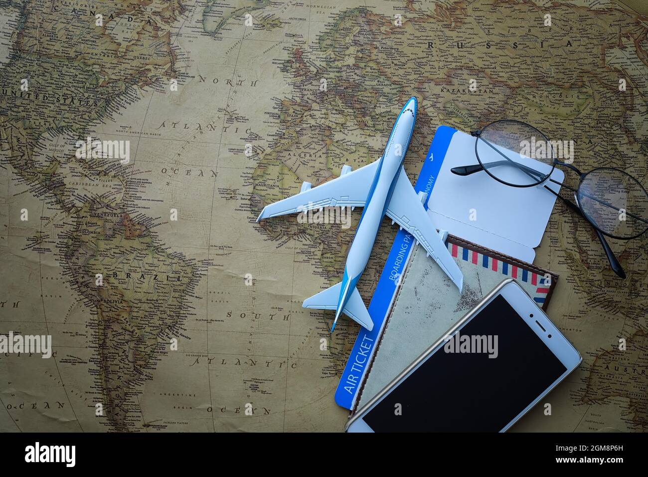 Travel concept. Map on the table and model aircraft Stock Photo - Alamy