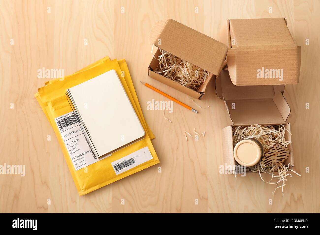 Preparing parcels for shipment to customer on table Stock Photo - Alamy