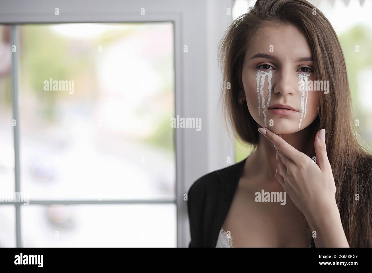 Beautiful girl with tears in eyes. Young girl with painted tears posing ...