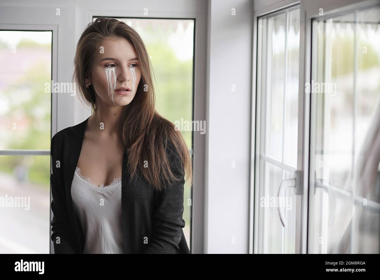 Beautiful girl with tears in eyes. Young girl with painted tears posing ...