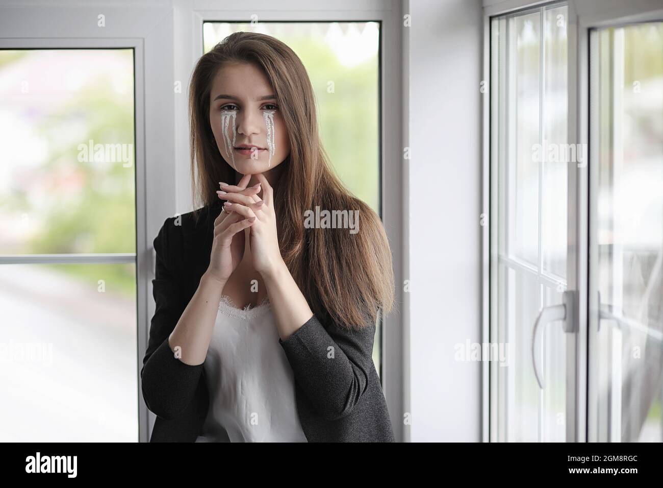 Beautiful girl with tears in eyes. Young girl with painted tears posing ...