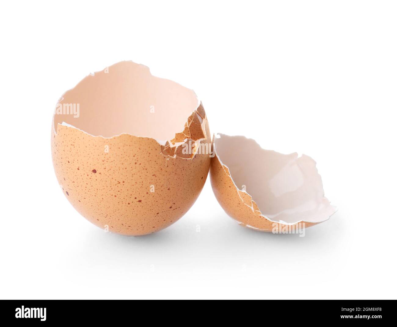 Cracked egg shell on white background Stock Photo - Alamy