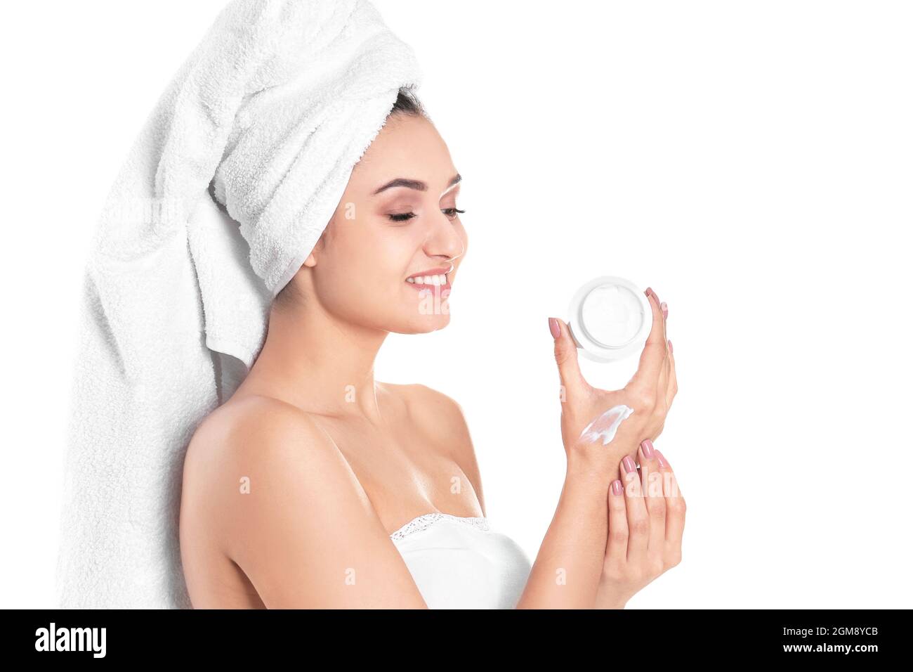 Woman applying hand cream on white background Stock Photo - Alamy