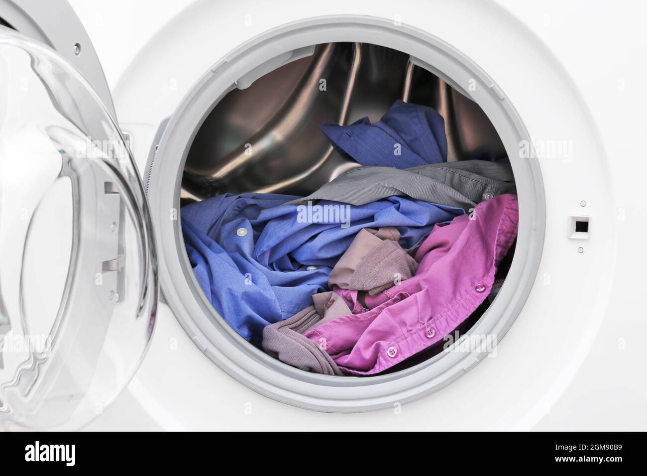 Washing machine with clothes, closeup. Laundry day Stock Photo - Alamy