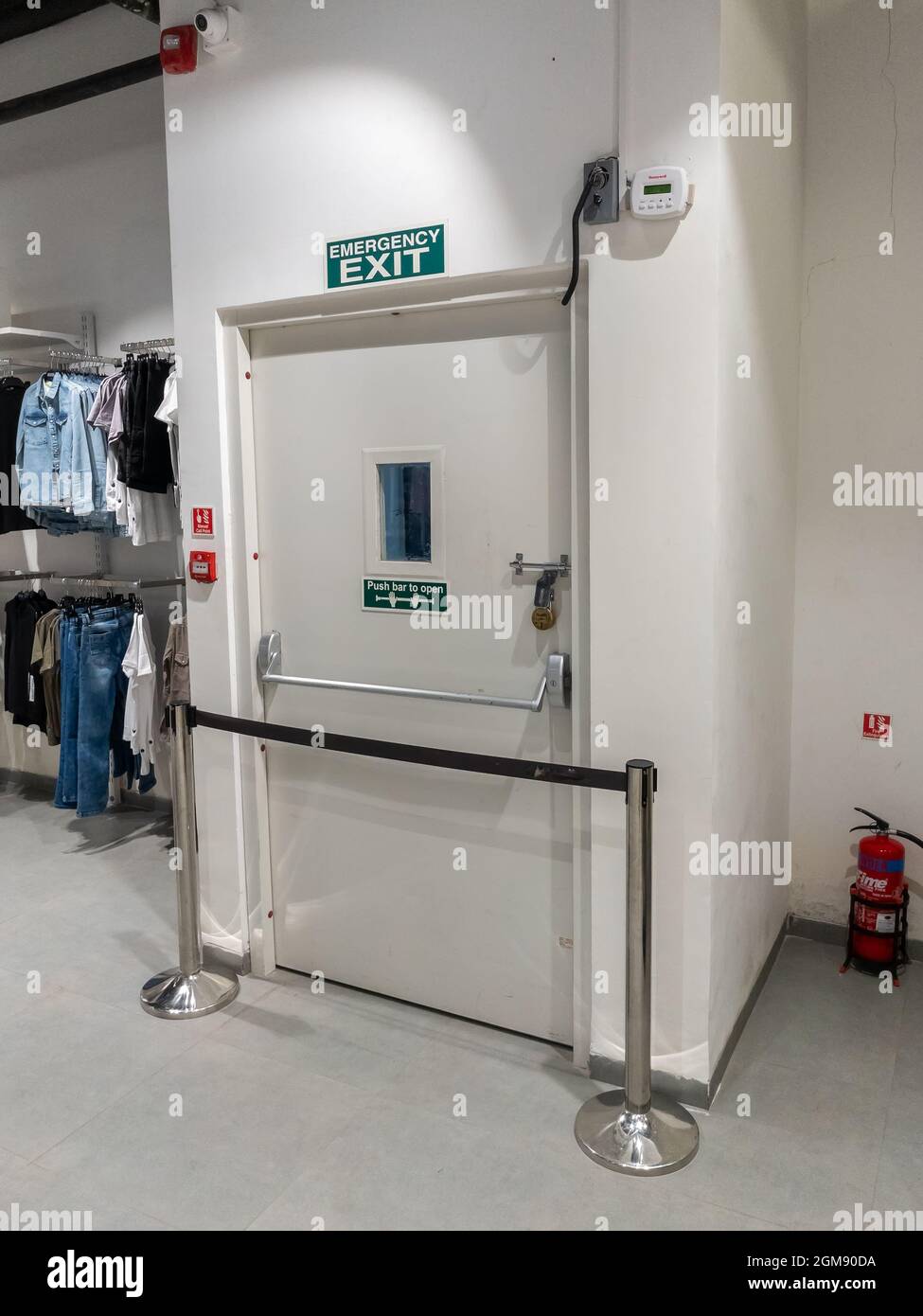An exit door indicating the emergency exit sign board and alarm system ...
