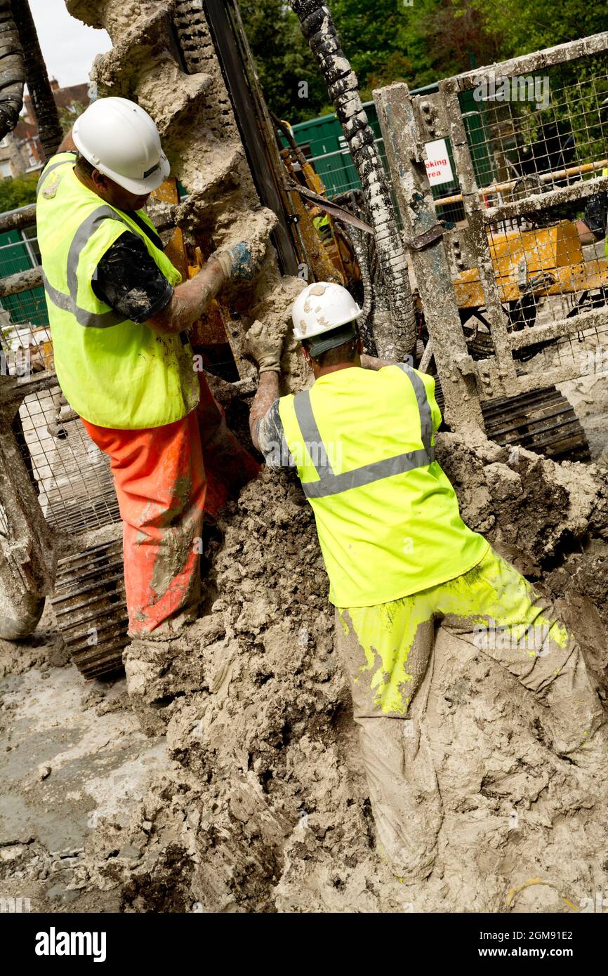Clearing the auger of a piling rig being used in the construction of ...
