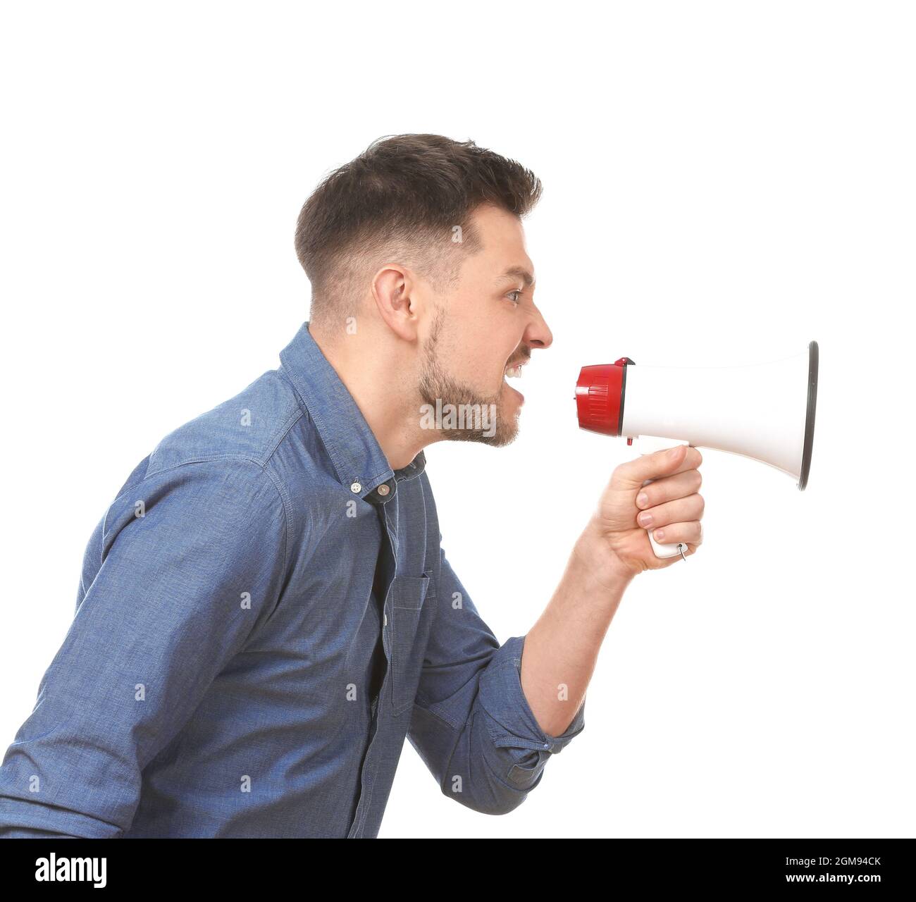 Angry man using megaphone against white background Stock Photo - Alamy