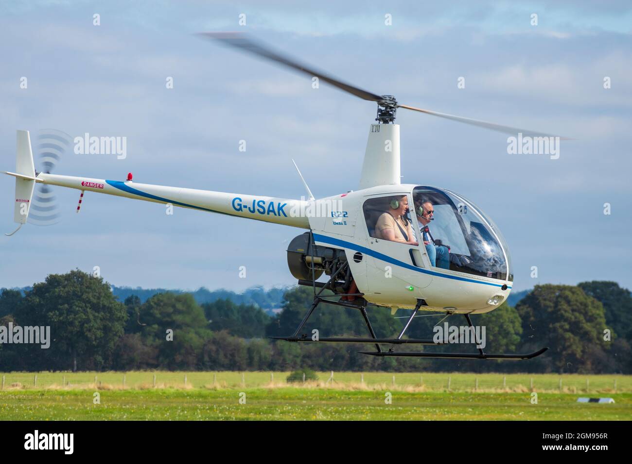 A Robinson R22, a small two-seat helicopter Landing at Headcorn ...
