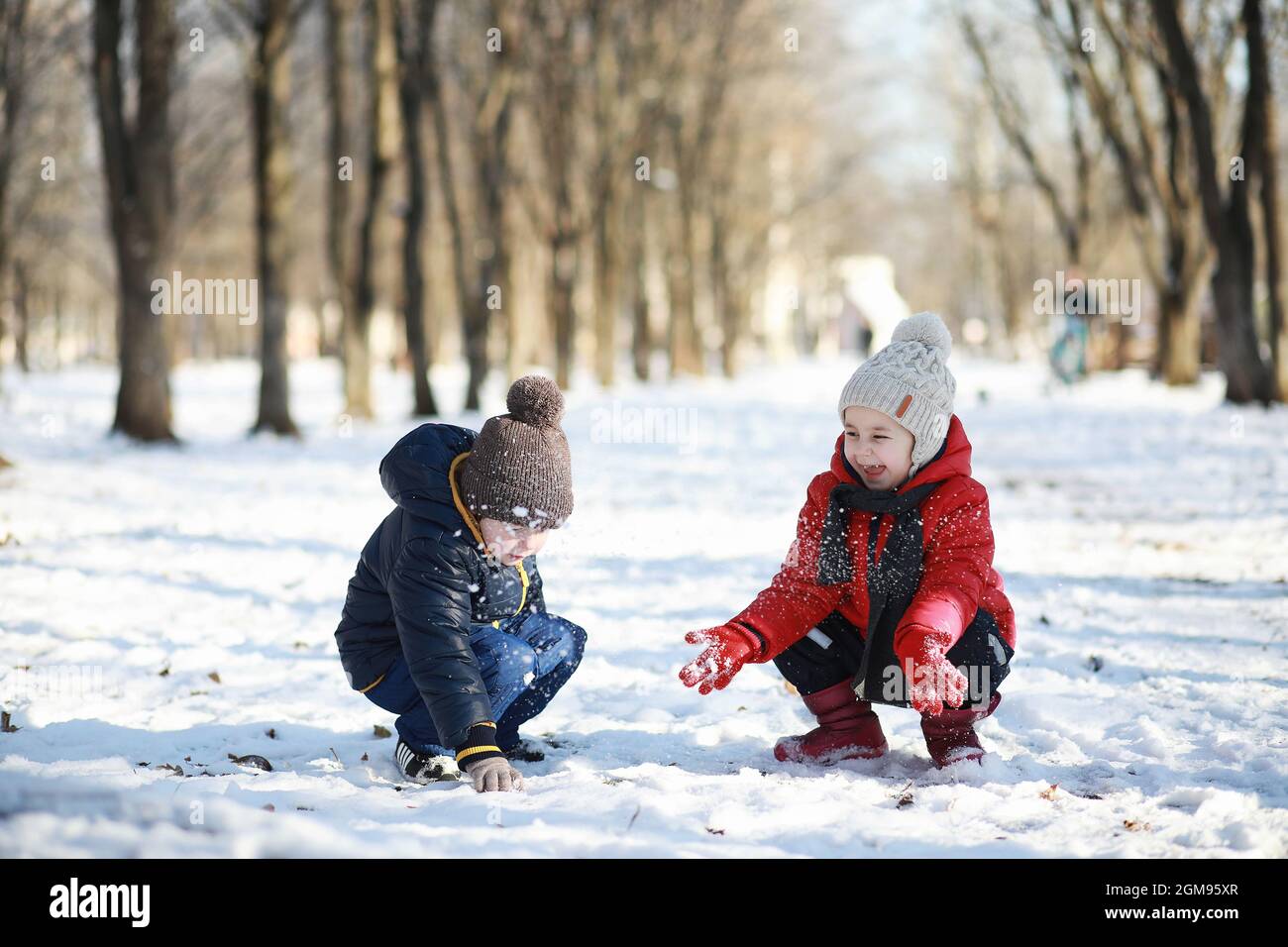 children in winter park play with snow Stock Photo - Alamy