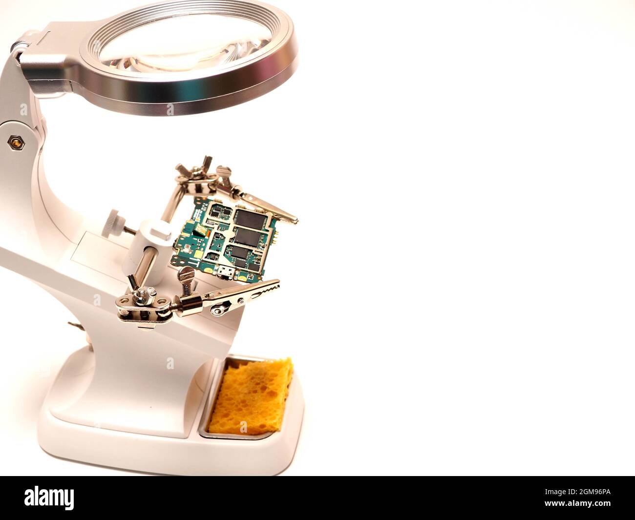 Close up shoot of printed circuit board (PCB) sitting on a white repair ...