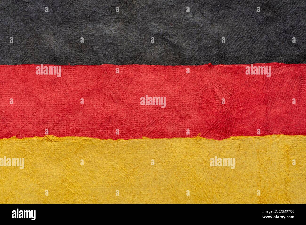 paper abstract in colors of Germany national flag - black, red and gold ...