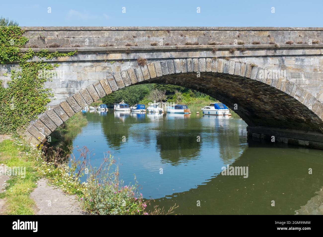 The River Dart passes under the old stone bridge at Bridgetown in the ...