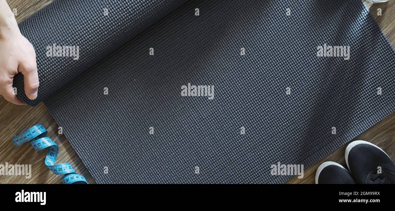 Mat for practicing yoga on a floor. Healthy lifestyle Stock Photo - Alamy