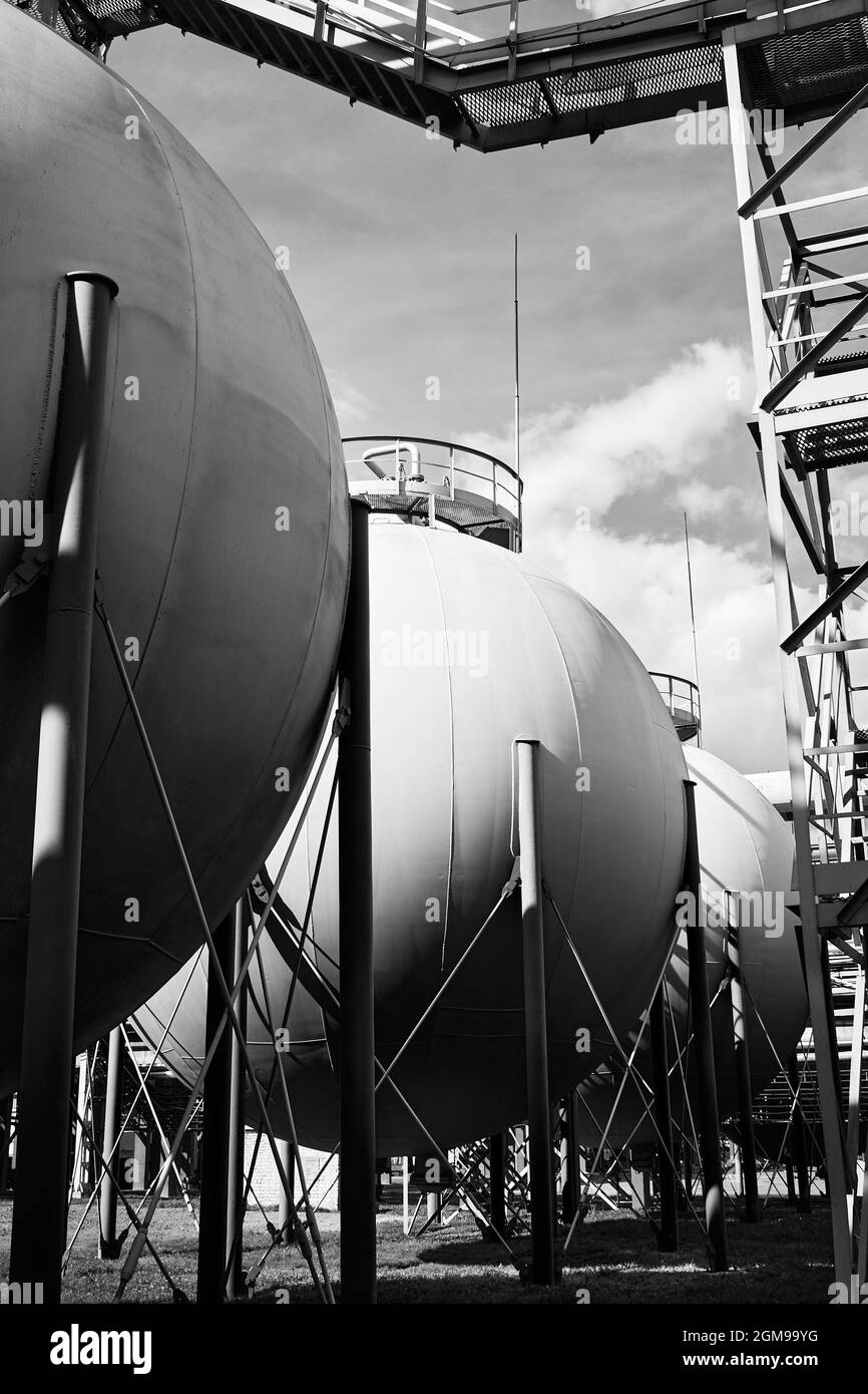 Industrial landscape bottom up view on several spherical gasholders ...