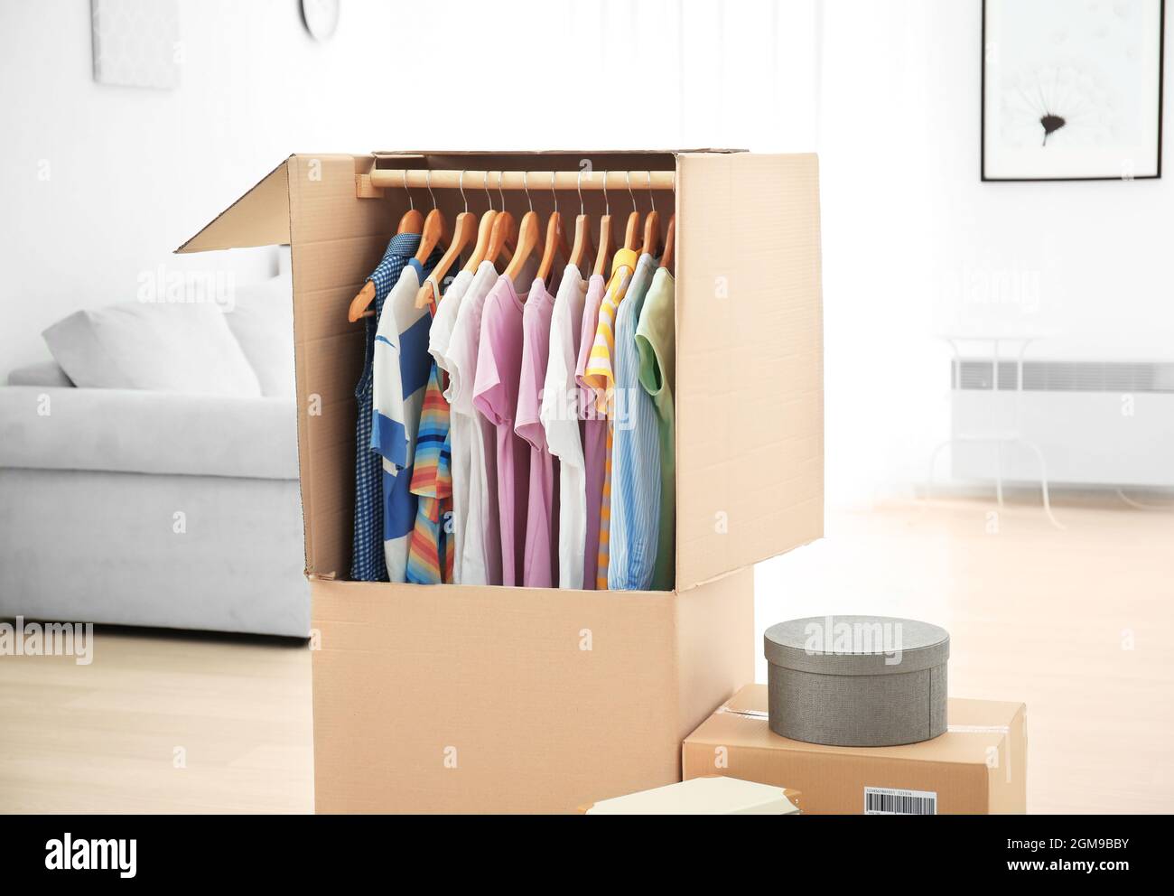 Wardrobe boxes with clothes indoors Stock Photo - Alamy