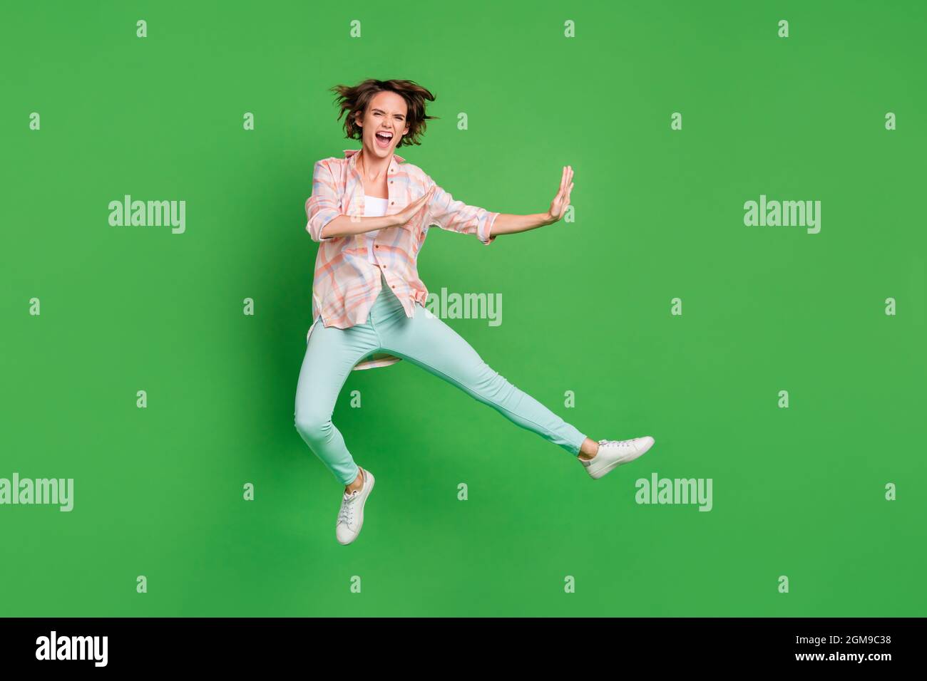 Full body photo of angry aggressive young woman jump up fight empty ...