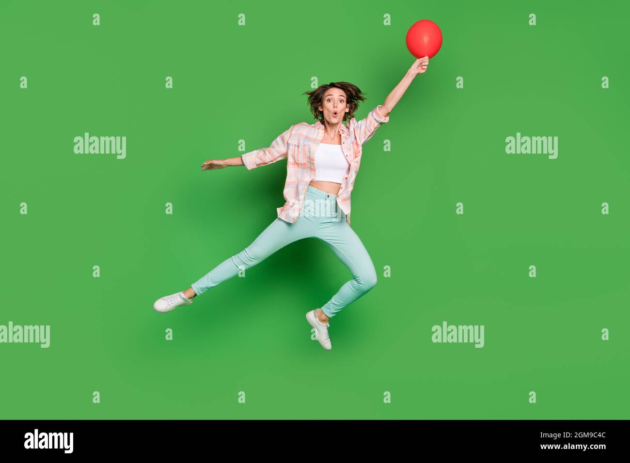 Full size photo of amazed brunette haired young woman jump up catch ...