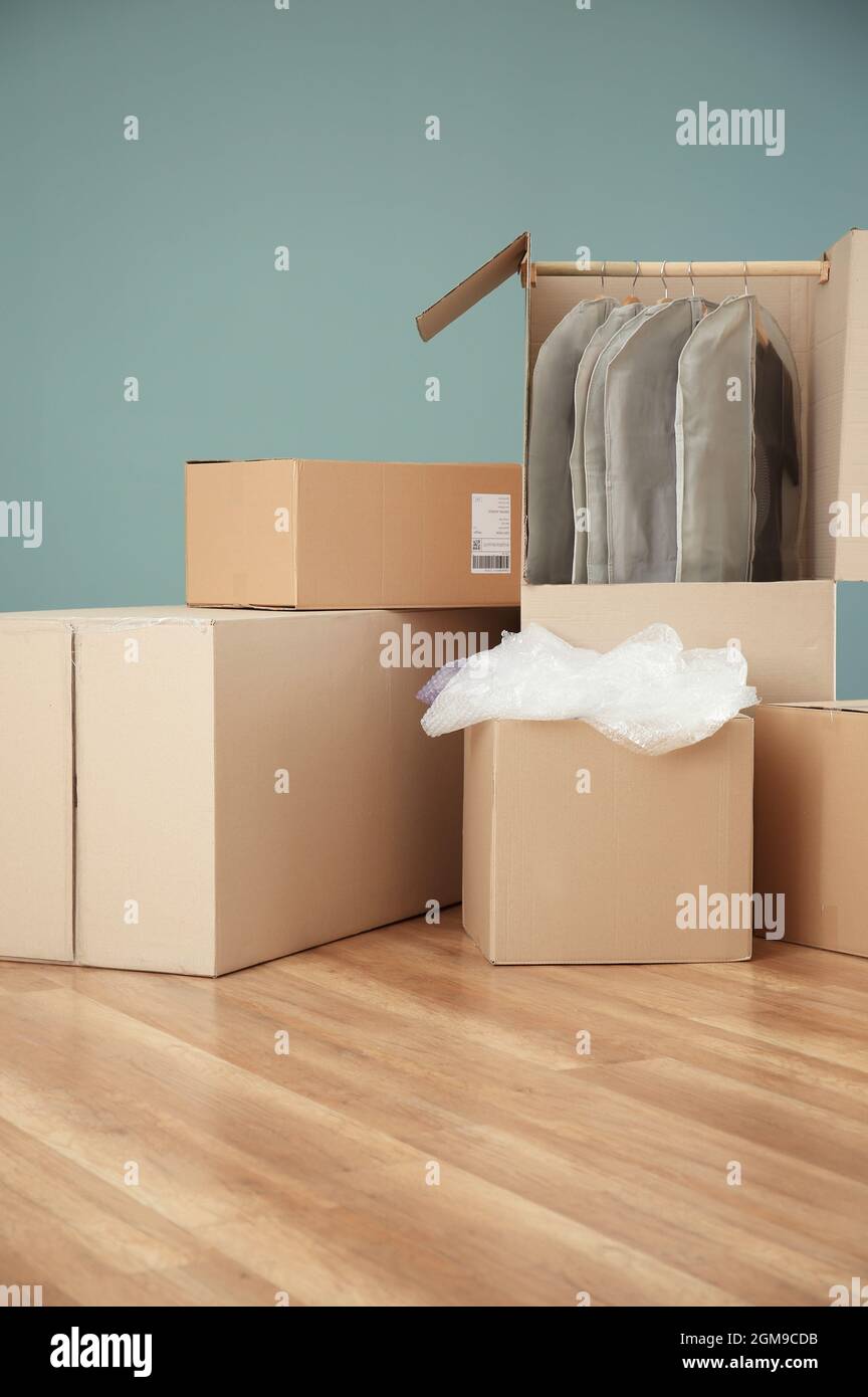 Wardrobe boxes with clothes indoors Stock Photo - Alamy