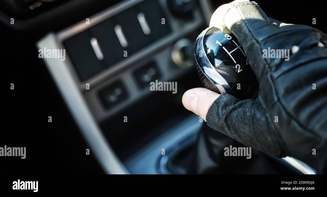 Gear lever. Manual Transmission. Hand on the gear shift in a car Stock ...