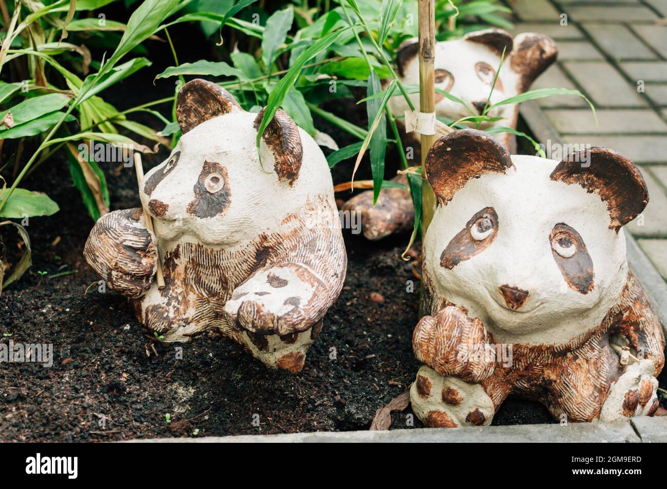 Closeup of the small panda statues for garden decoration Stock Photo ...