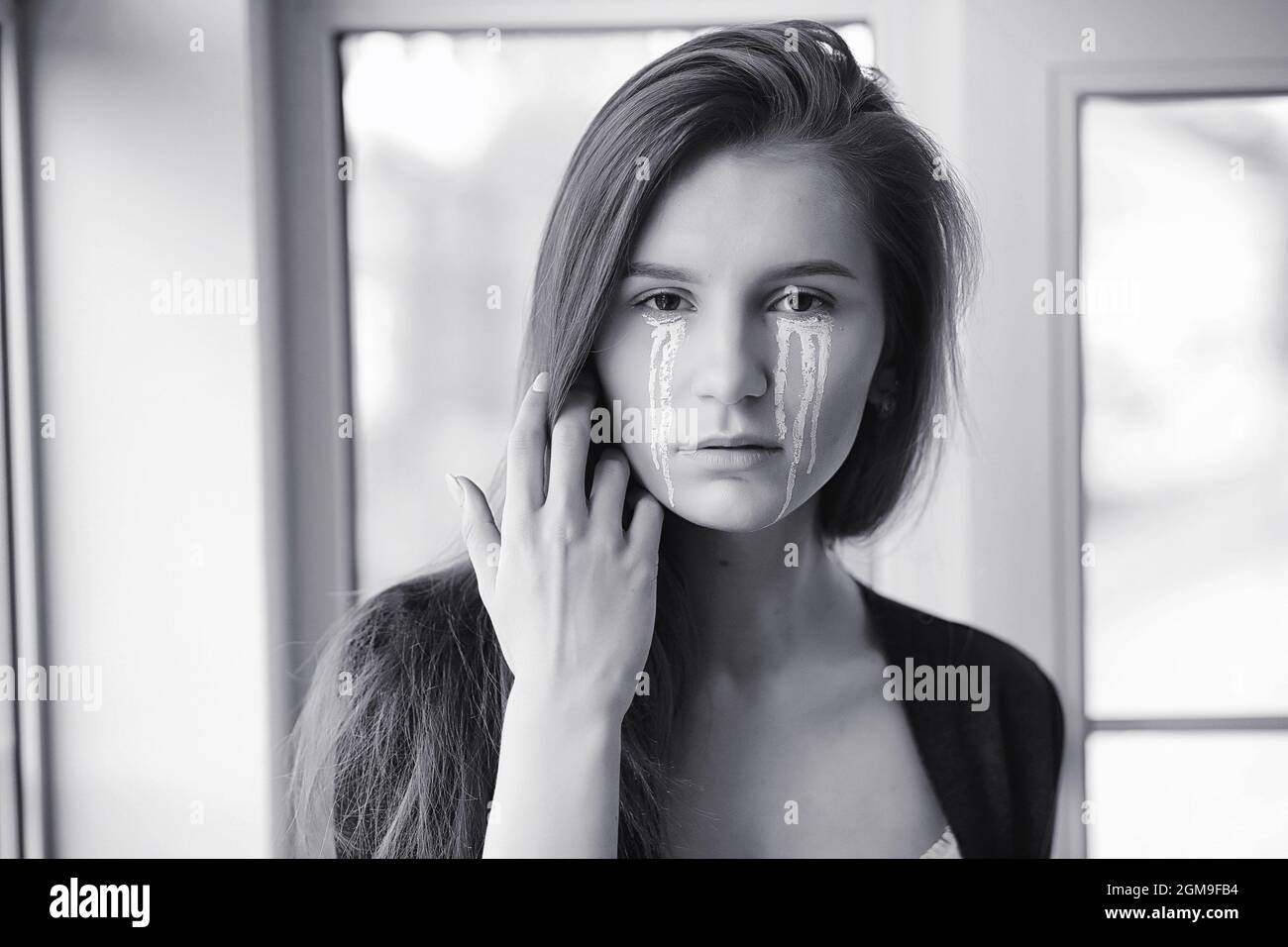 Beautiful girl with tears in eyes. Young girl with painted tears posing ...
