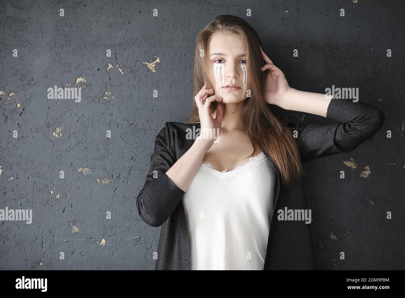 Beautiful girl with tears in eyes. Young girl with painted tears posing ...