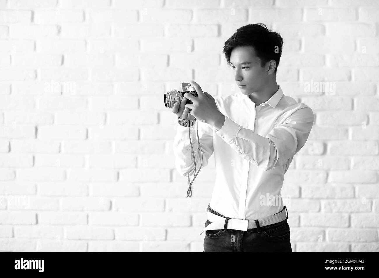 Asian man taking photograph Black and White Stock Photos & Images - Alamy