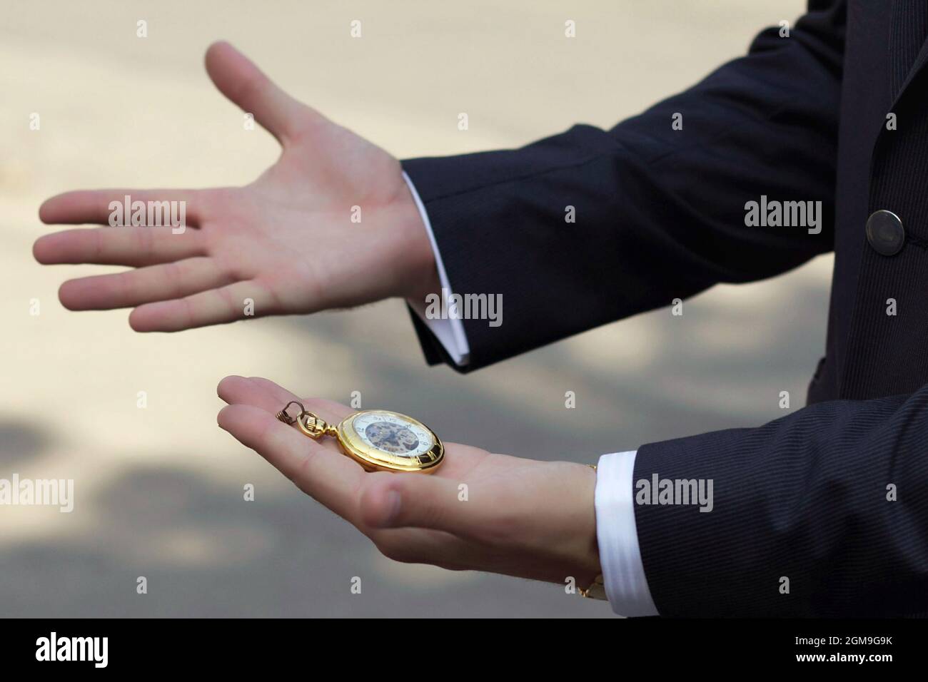 A man holds a classic pocket watch in his hand Stock Photo - Alamy