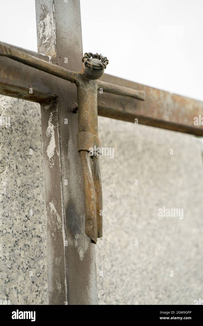 Vertical shot of a rusty metal cross with Jesus Christ on it Stock ...