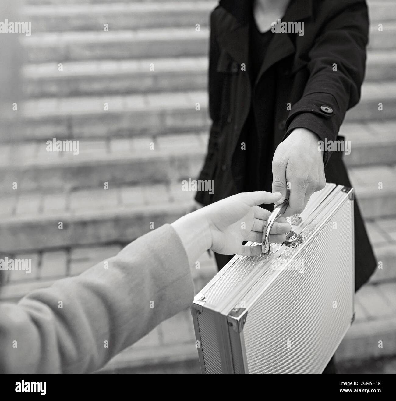 Asian man with a metal suitcase in the city. Asian and silver case ...