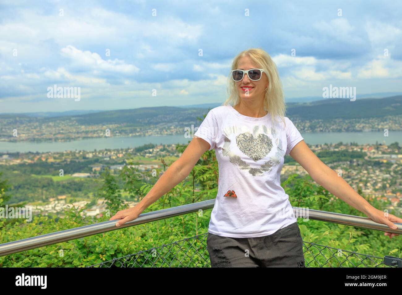 Lady on top of Zurich cityscape from top of Felsenegg cable car with ...