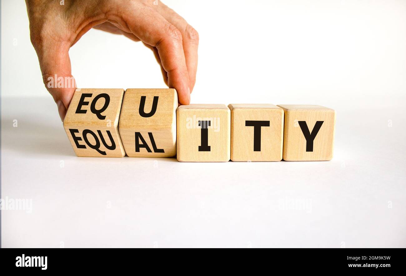 Equity and equality symbol. Businessman turns wooden cubes and changes ...