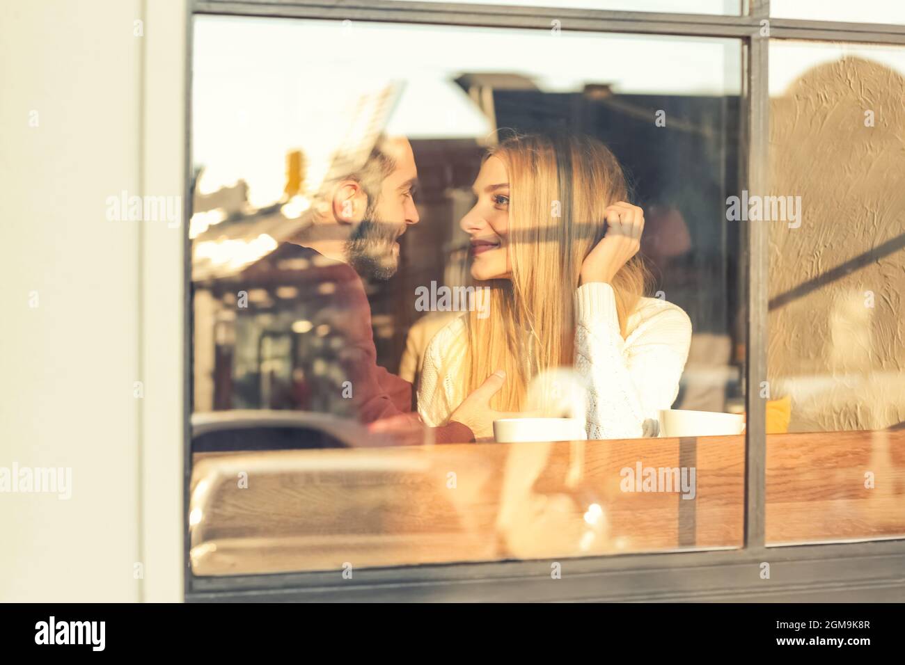 Young romantic couple in cafe, view from outdoors through window Stock ...