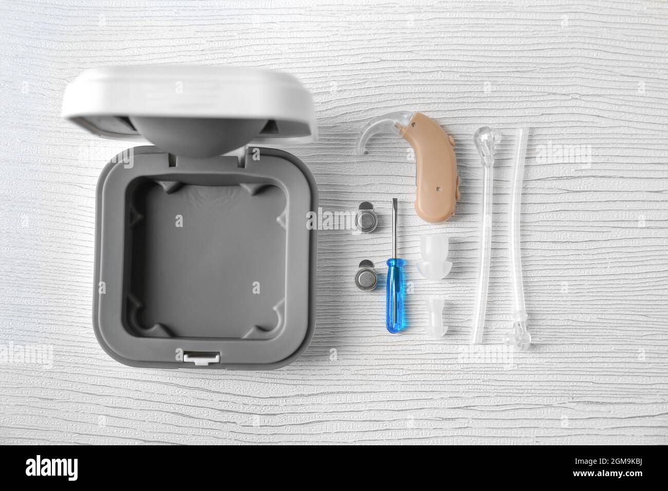 Composition with hearing aid and accessories on light background Stock ...