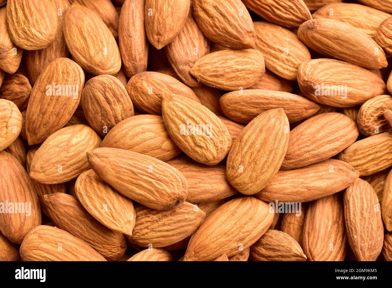 top view of badam, almonds textured background Stock Photo - Alamy