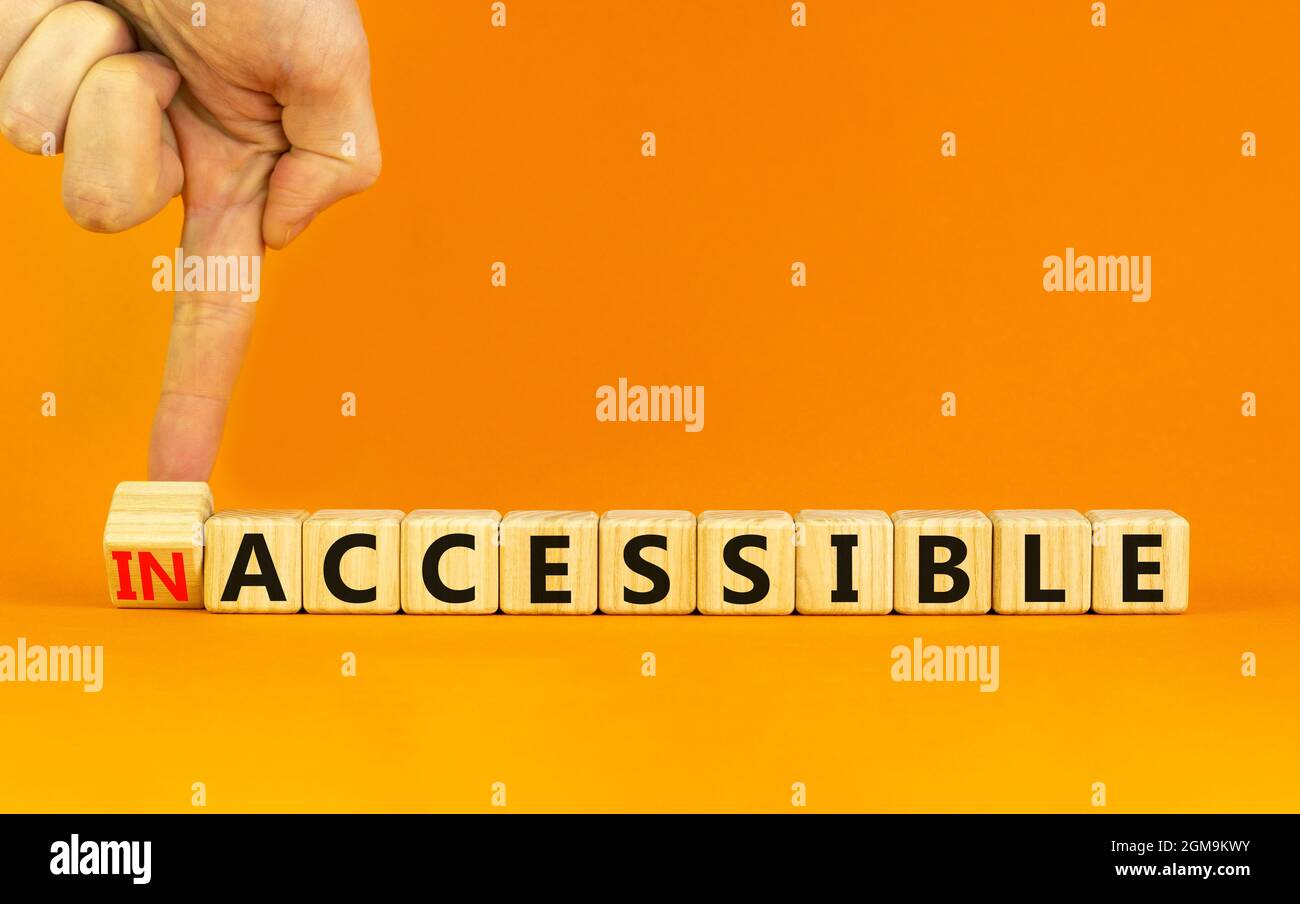 Accessible or inaccessible symbol. Businessman turns a wooden cube ...