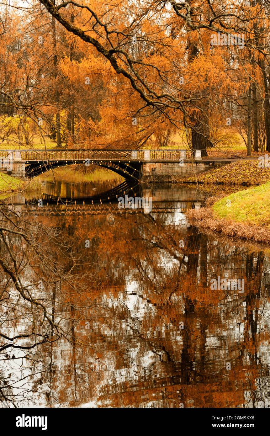Beautiful autumn landscape with an ancient bridge and reflections of ...