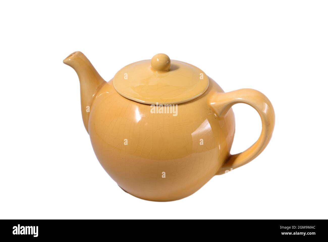 Yellow porcelain teapot on an isolated white background Stock Photo - Alamy