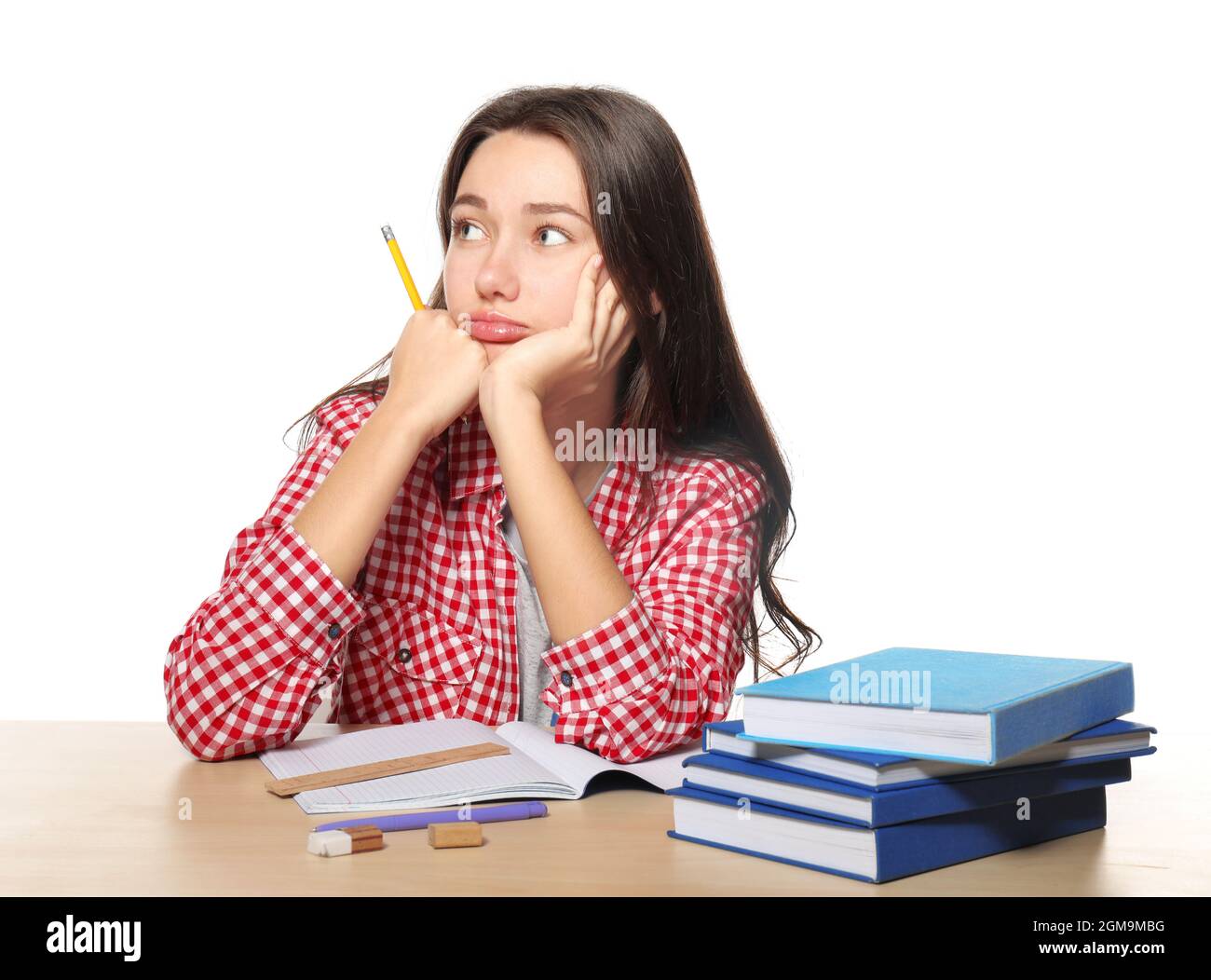 Teenager girl unwilling to do homework against white background Stock ...
