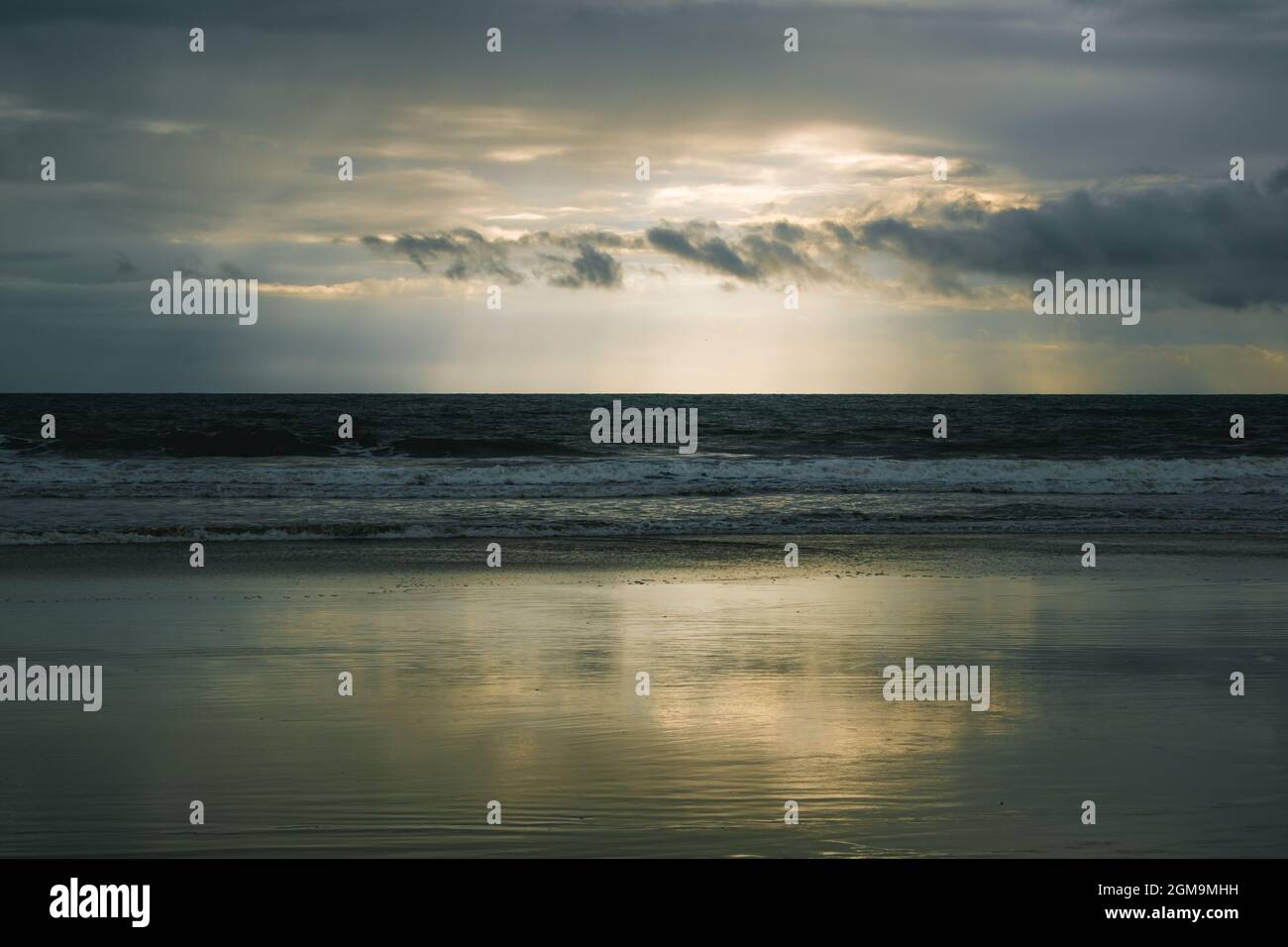 Monsoon Evening on a beach captured as the sun disappears below the ...