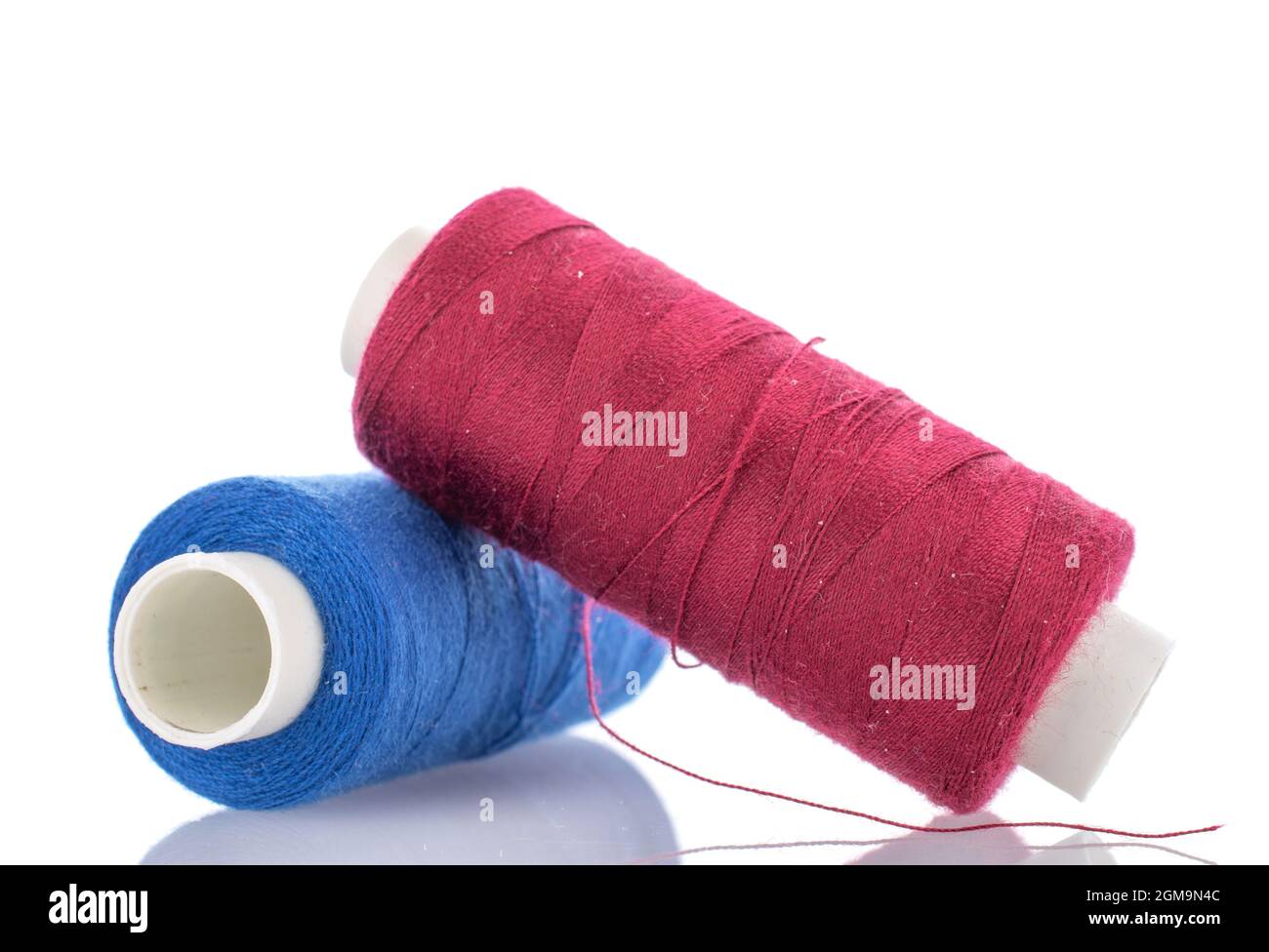 Two spools of colored thread, close-up, isolated on white Stock Photo ...