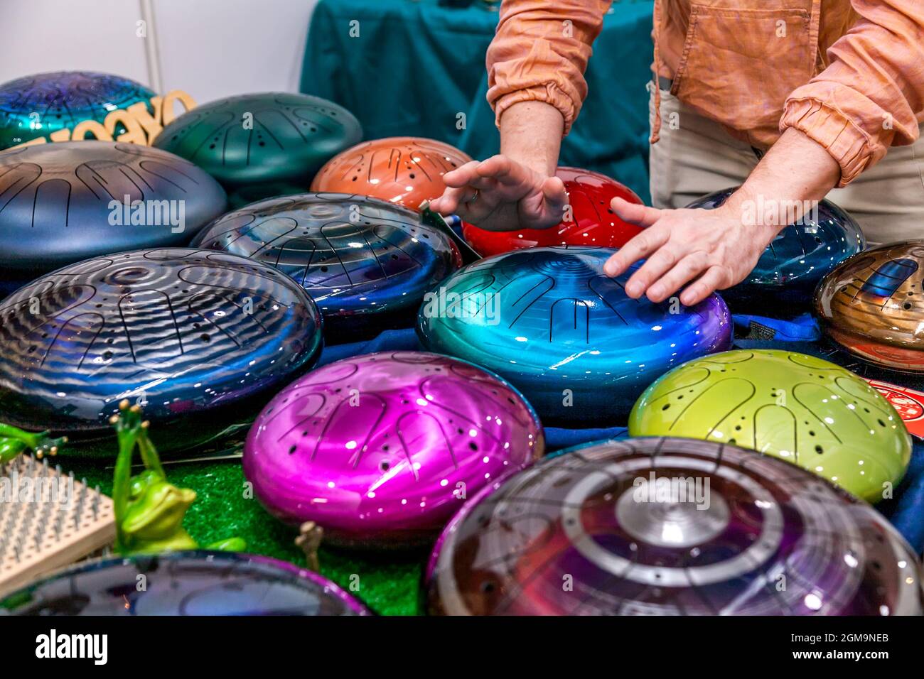 Exhibition and sale of unusual musical instruments - tank drum. Man ...