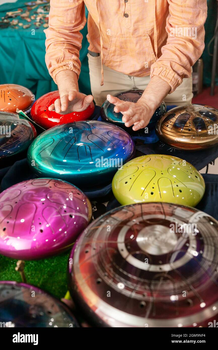 Exhibition and sale of unusual musical instruments - tank drum. Man ...