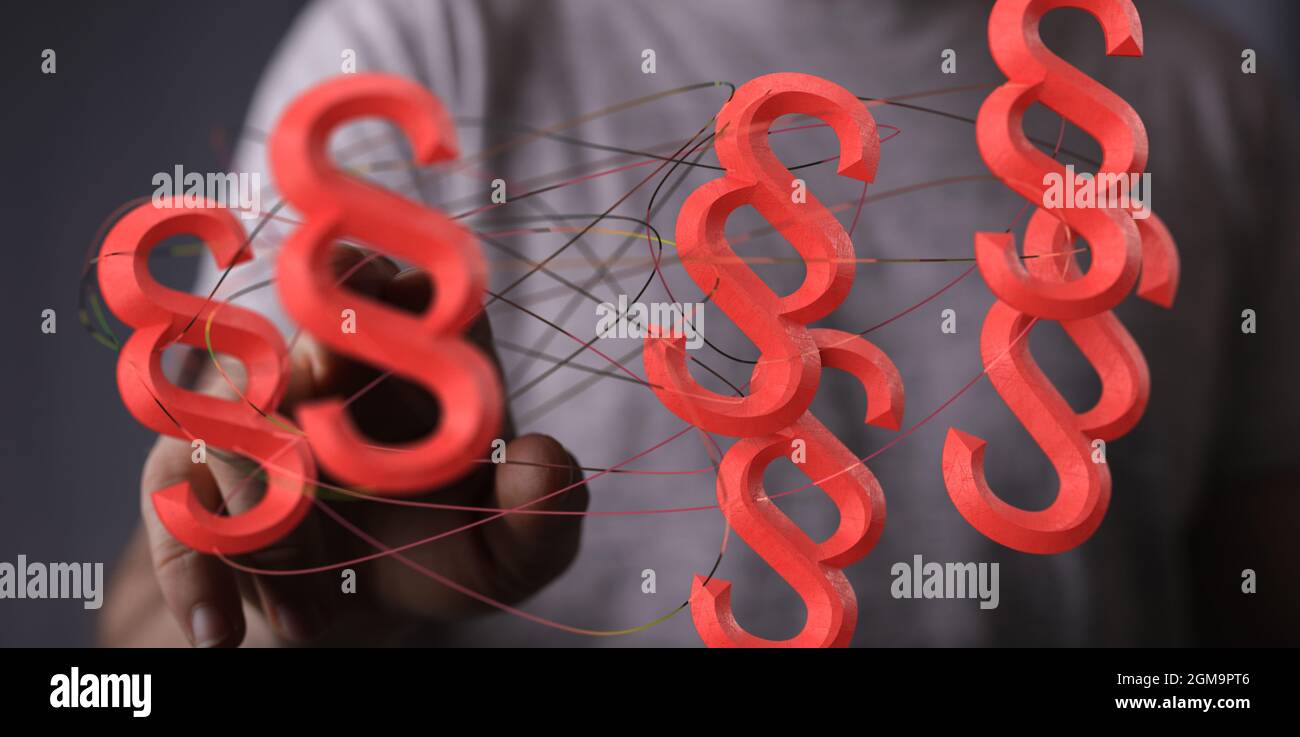 Man tapping on a 3D rendering of section sign symbols - legal ...