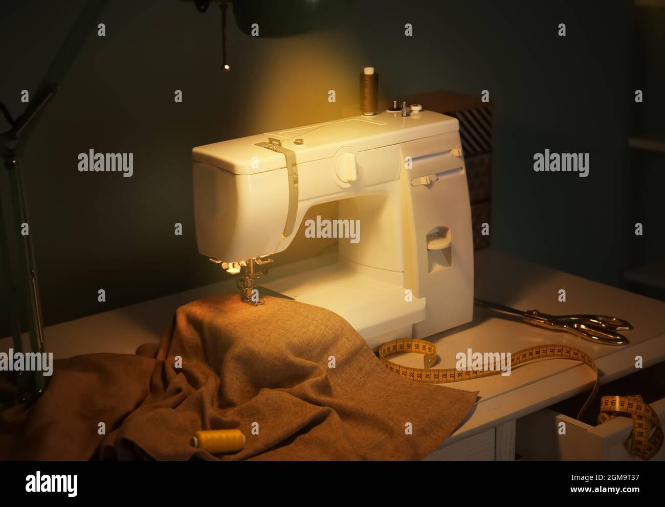 Tailor desk with modern sewing machine Stock Photo - Alamy