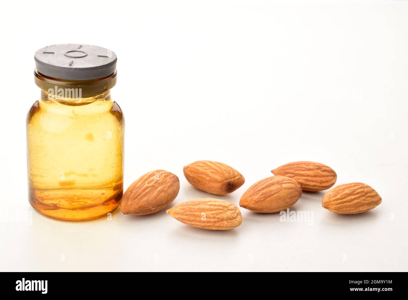 Almond oil isolated on white background Stock Photo - Alamy
