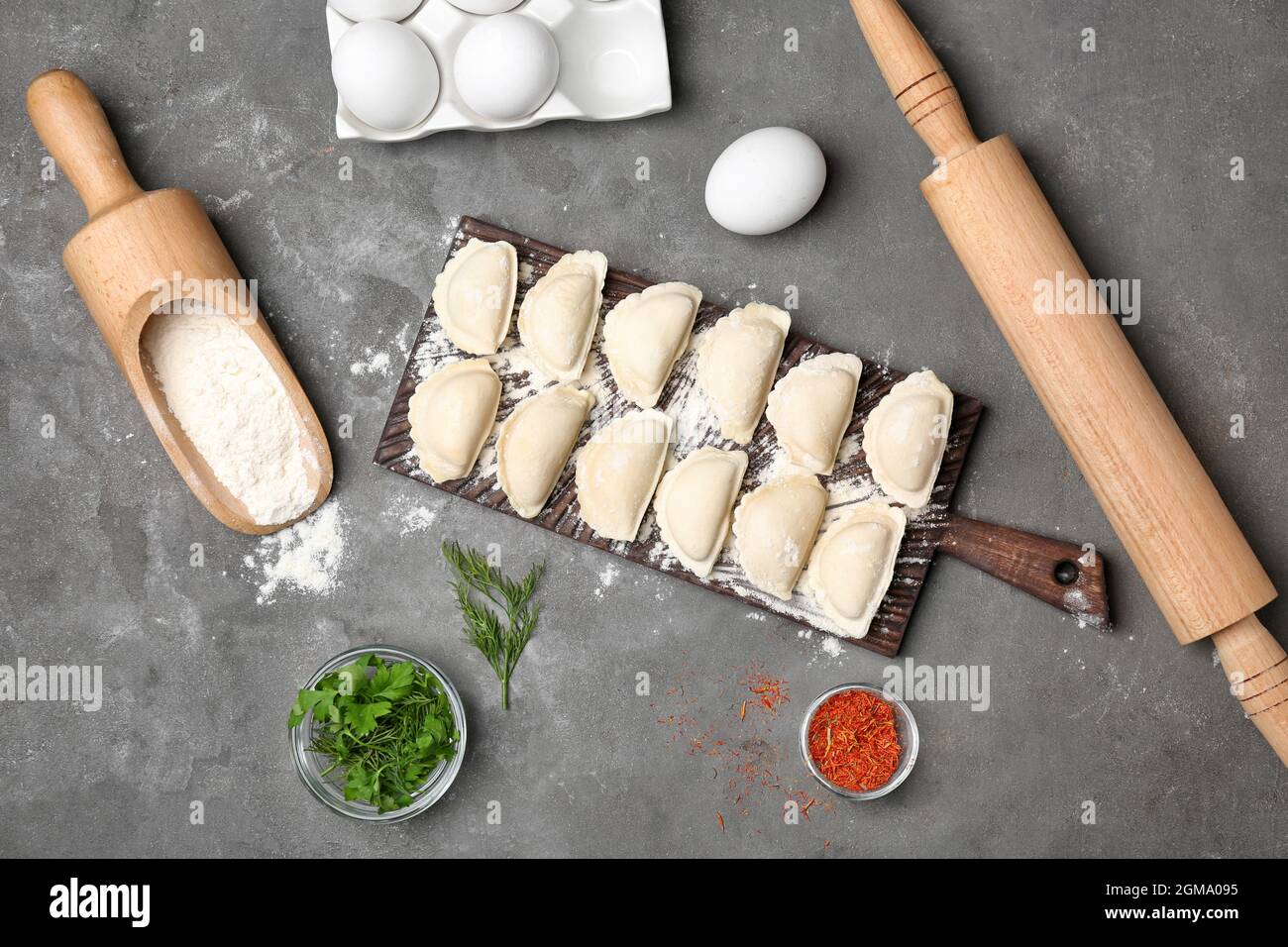 Wooden board with raw dumplings on table, top view Stock Photo - Alamy