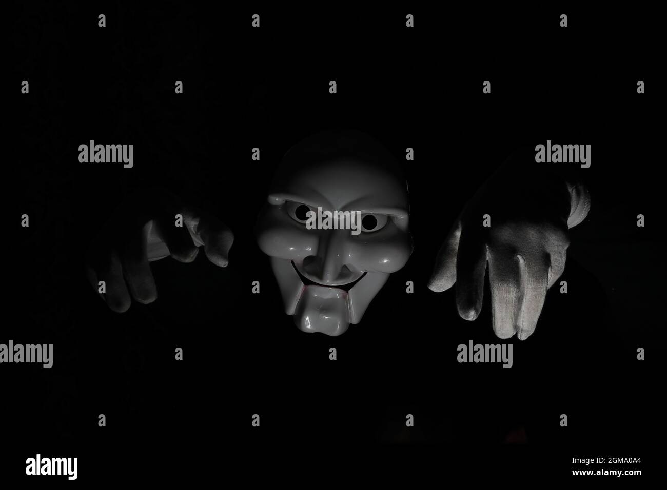 White scary mask on a black background with whites hands Stock Photo ...