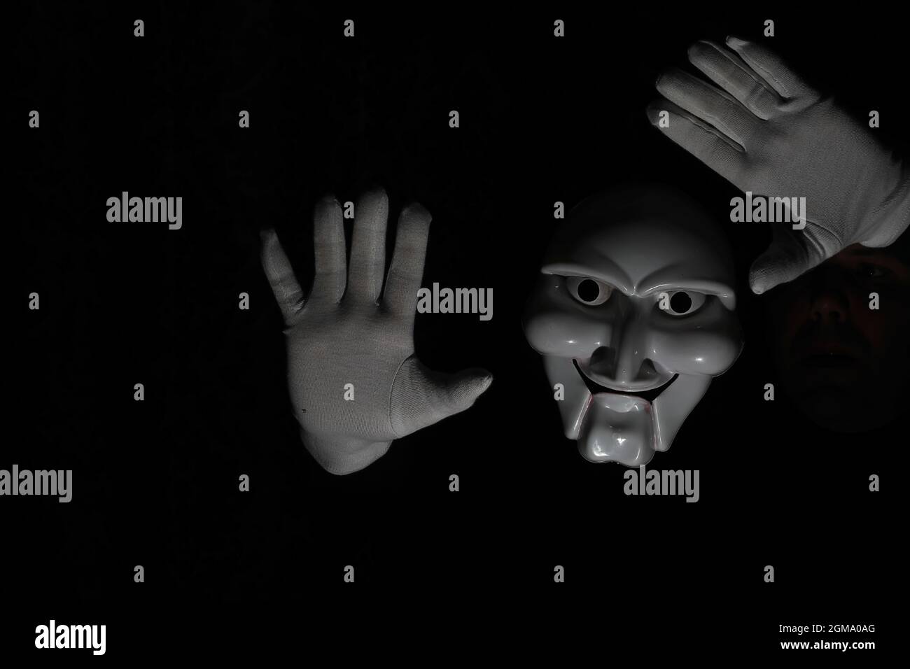 White scary mask on a black background with whites hands Stock Photo ...