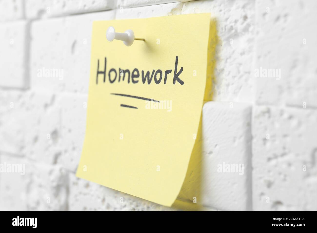 Note with word "Homework" pinned to wall Stock Photo - Alamy